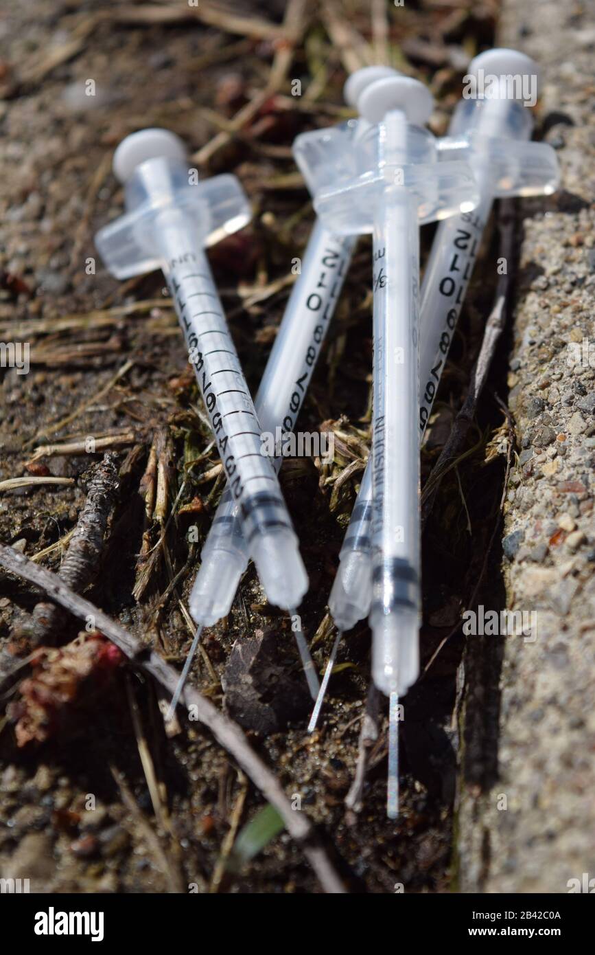 Used needles discarded in a public park. Opioid crisis pollution ...