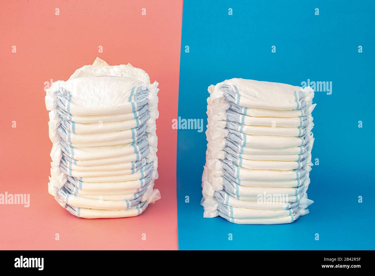 A couple of diapers stack on a blue and pink background Stock Photo - Alamy