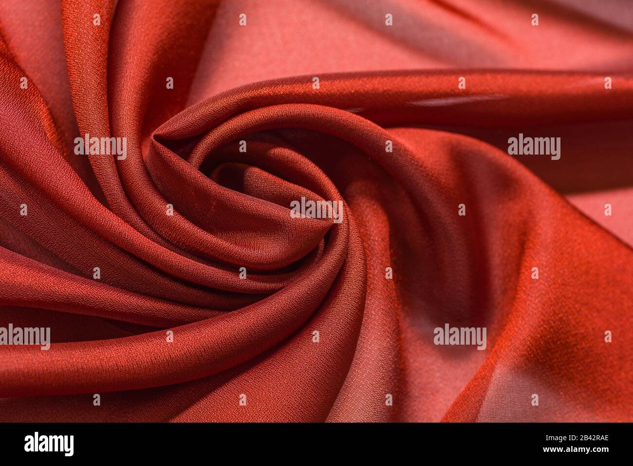 Shiny red cloth background dark curly background Stock Photo - Alamy
