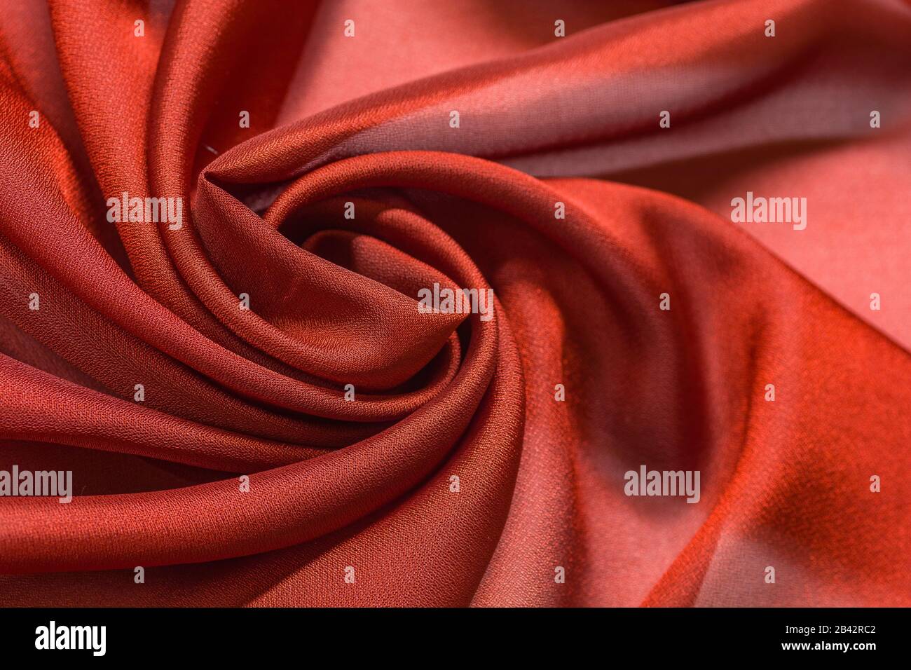 Shiny red cloth background dark curly background Stock Photo - Alamy