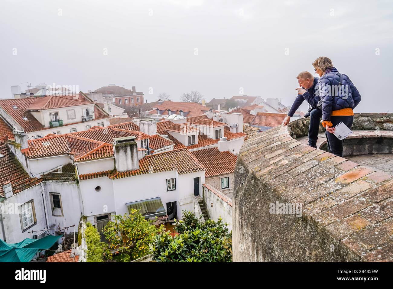 Tourists by the view point of São Jorge Castle, a historic castle in ...
