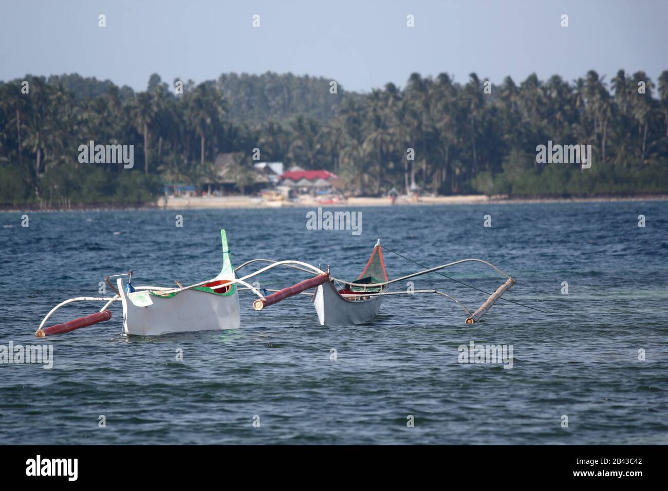 Outrigger boats floating in the bay in Surigao dle Sur, Philippines ...