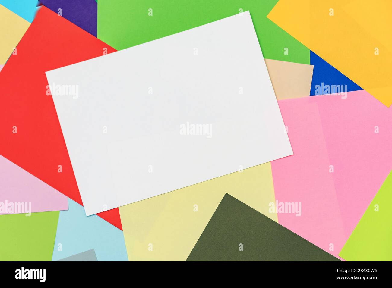 A multi-colored kaleidoscope of colored sheets of paper scattered ...