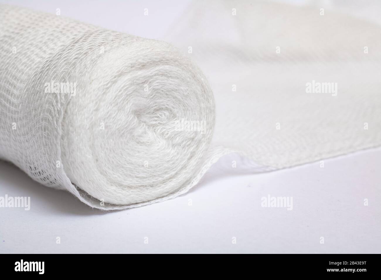Roll of medical bandage on white background Stock Photo - Alamy