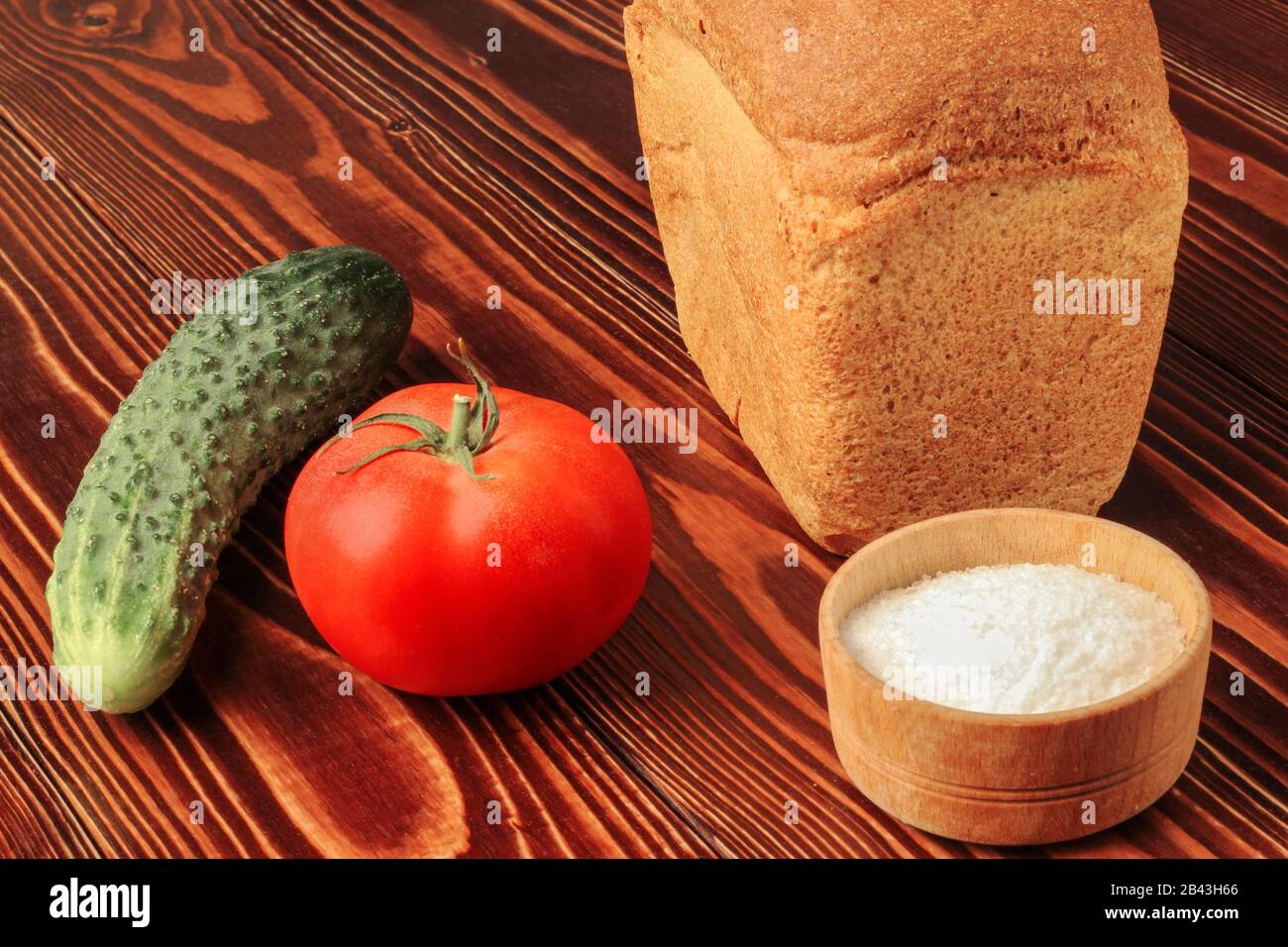 Bread with salt and vegetables on the table Stock Photo - Alamy