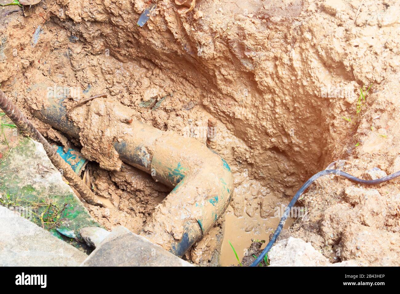 broken pipe in hole with water motion at roadside wait repair Stock ...
