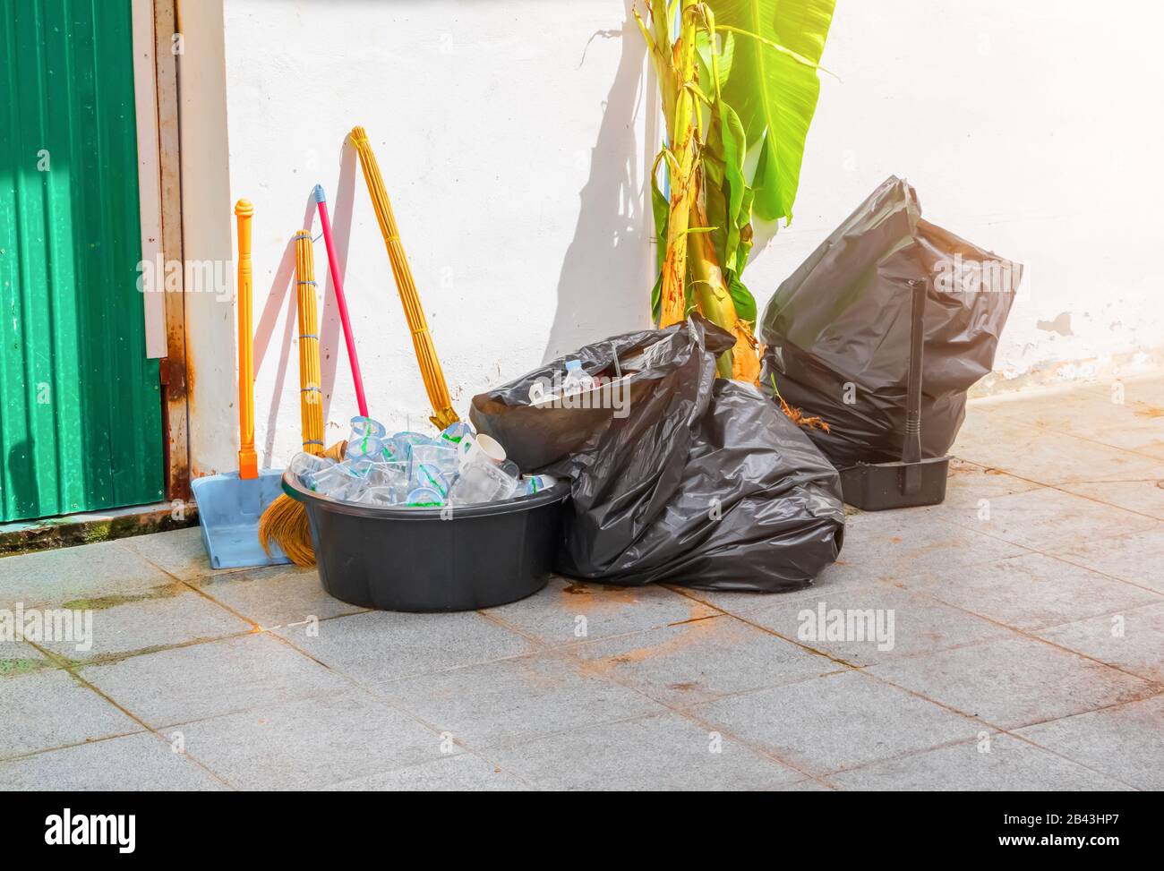 plastic trash bag. Pile black garbage On floor Beside the building wall ...