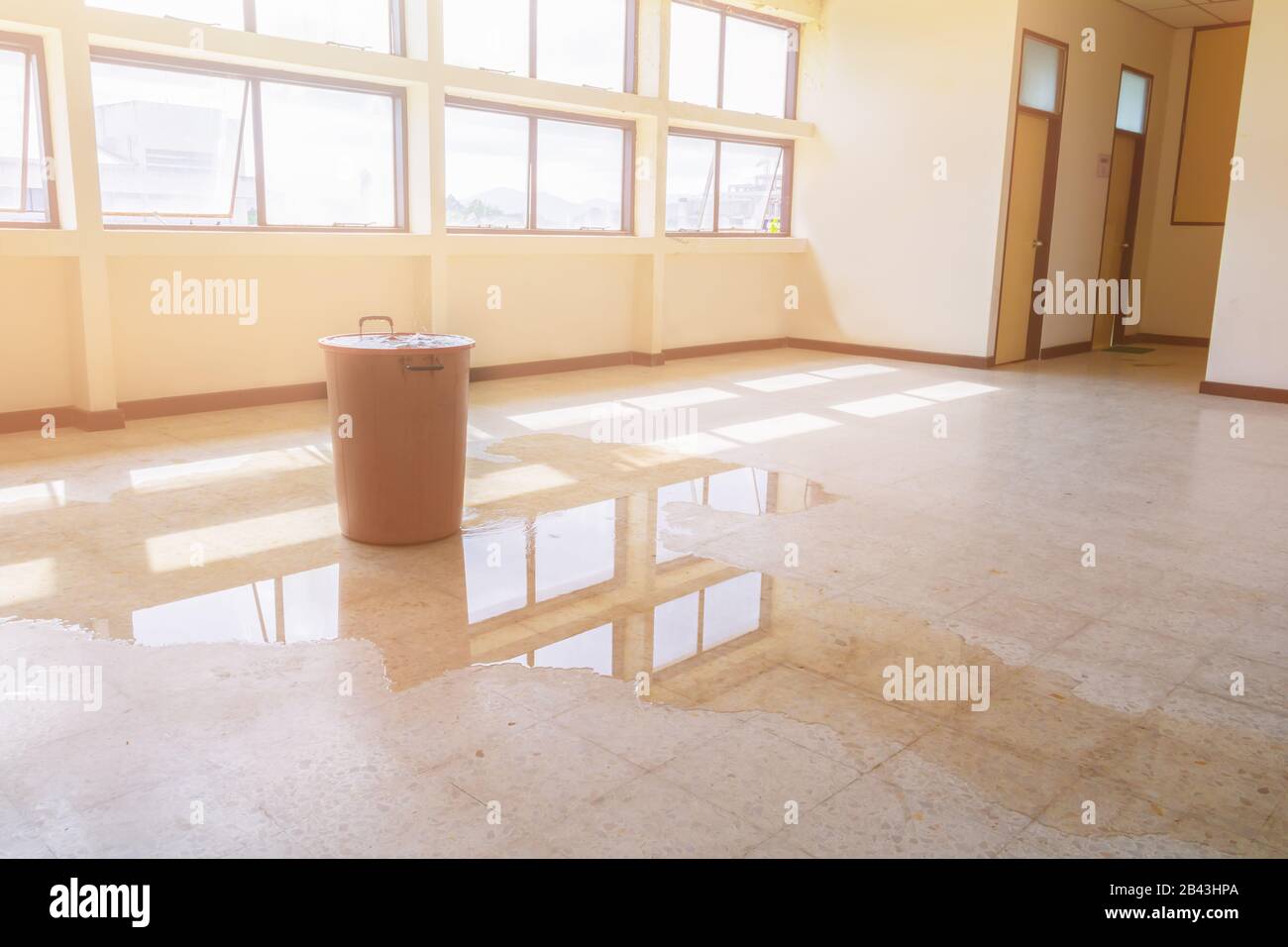 water leak drop interior office building in red bucket from Ceiling and ...