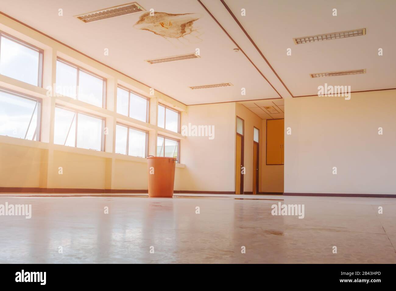 water leak drop interior office building in red bucket from Ceiling and ...