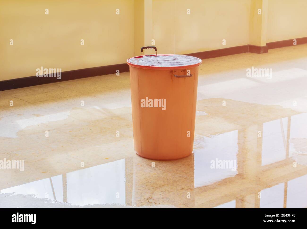 water leak drop interior office building in red bucket from Ceiling and ...