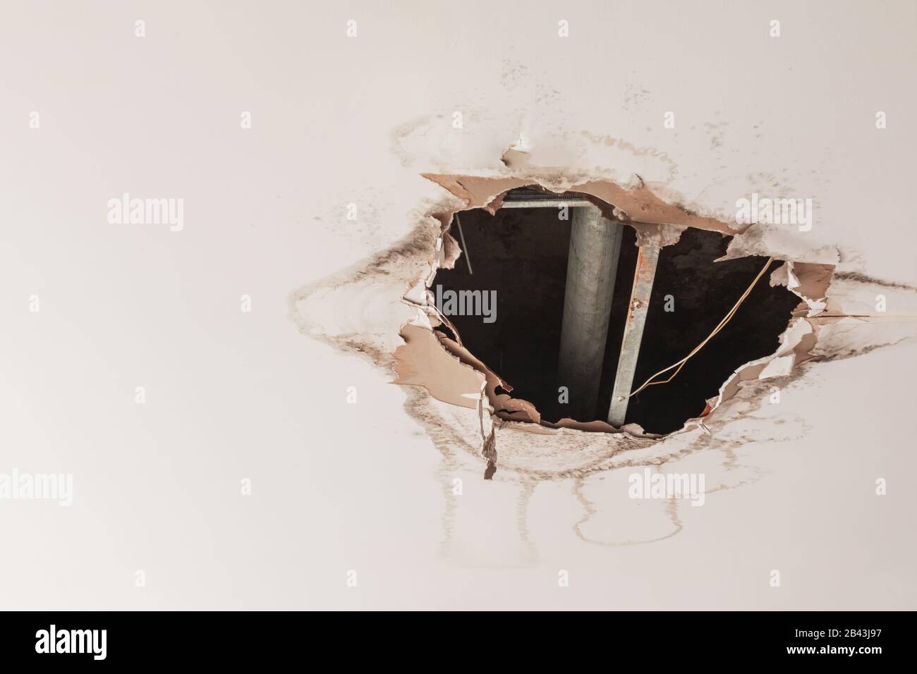 gypsum ceiling decay hole interior office building Stock Photo - Alamy
