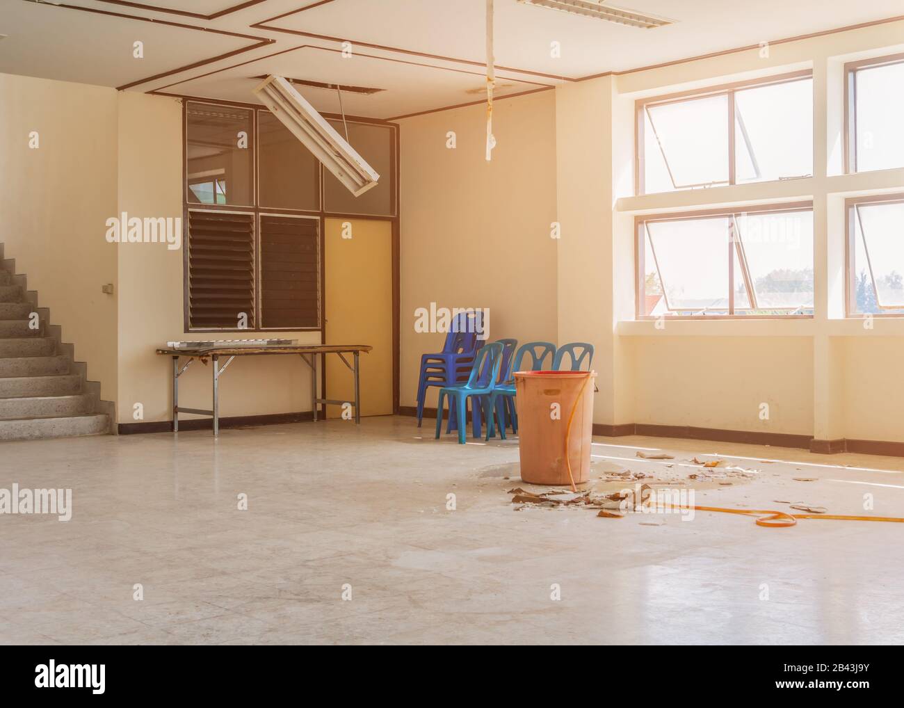 water leak drop interior office building in red bucket from gypsum ...