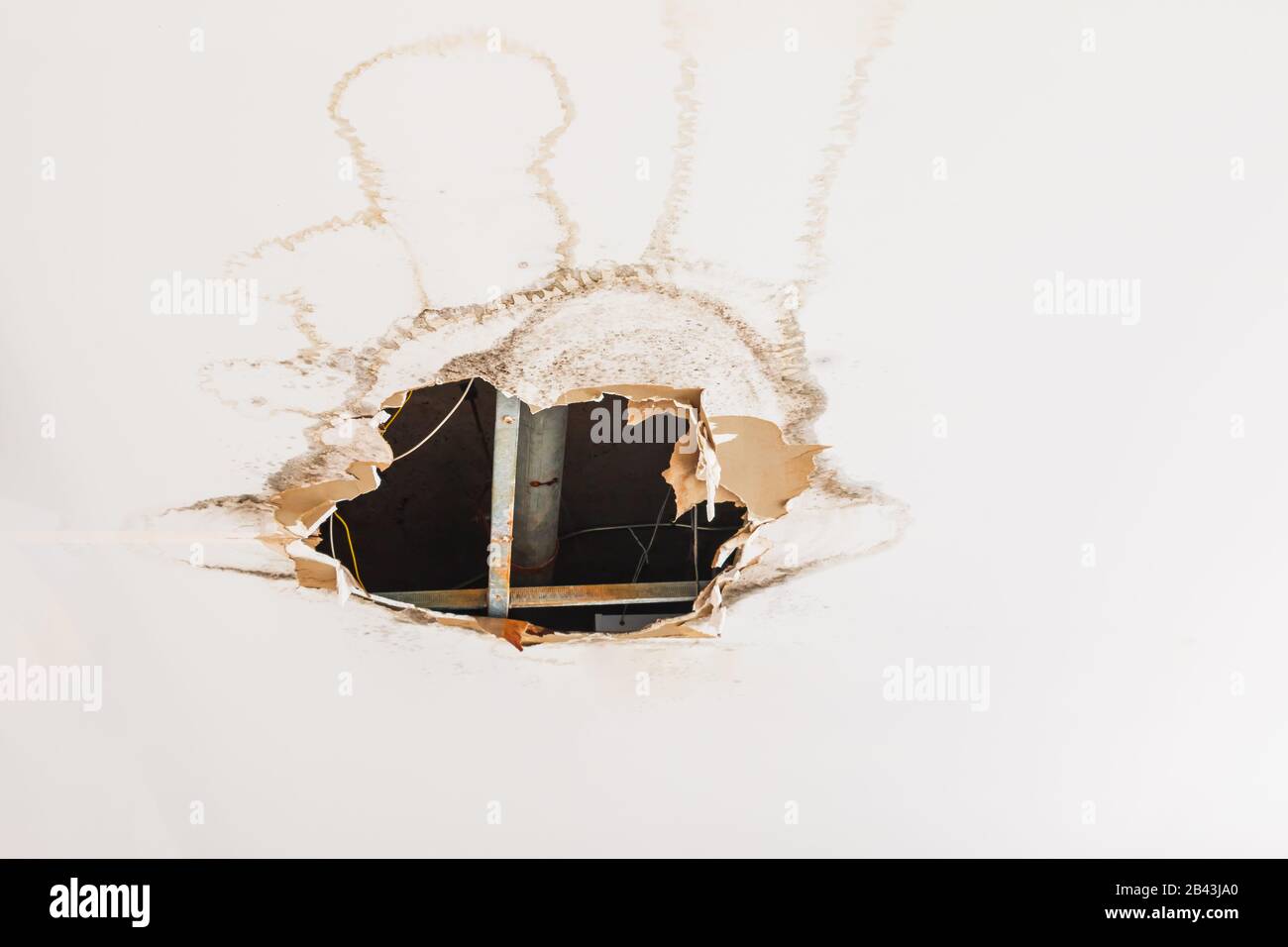 gypsum ceiling decay hole interior office building Stock Photo - Alamy