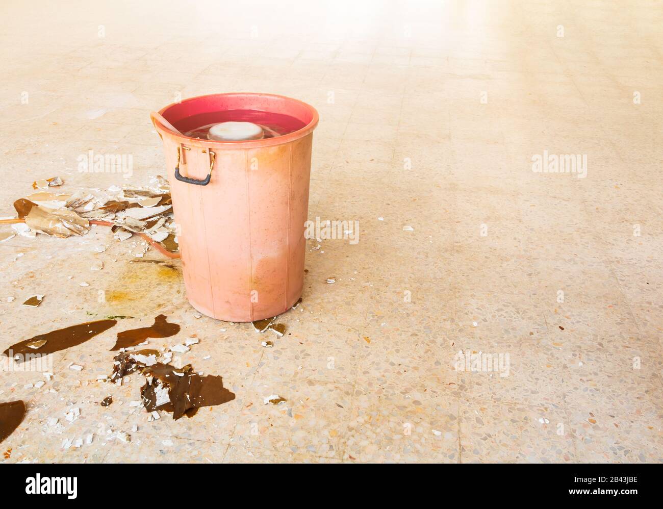 water leak drop interior office building in red bucket from gypsum ...