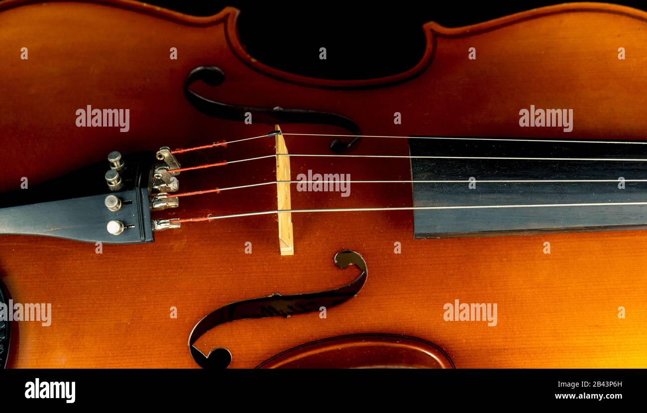 Studio photo of an aged violin shot against a black background Stock ...