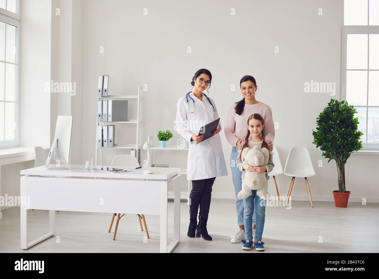 Happy family at the doctors visit at office Stock Photo - Alamy