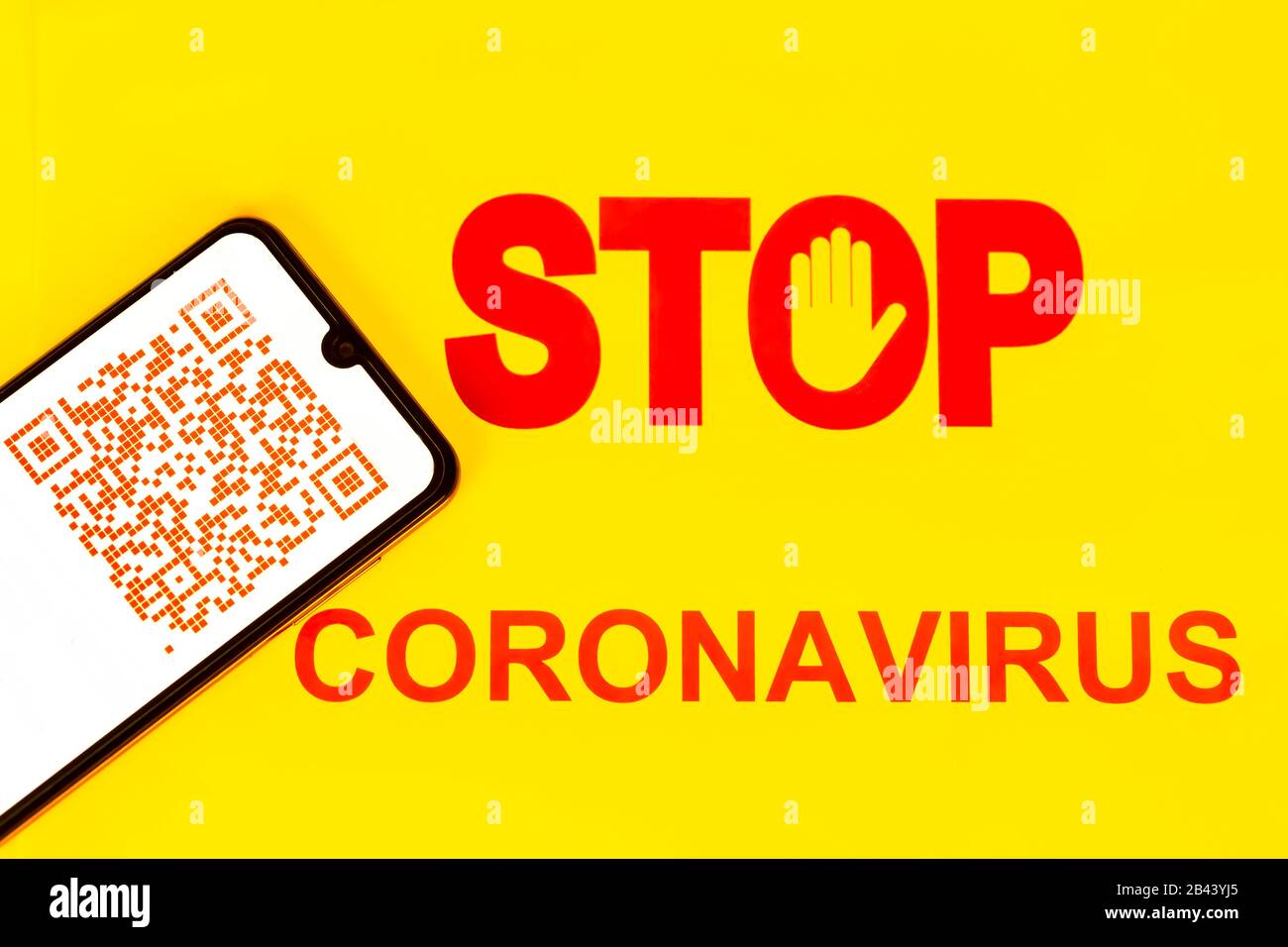 STOP Sign with orange colorful QR Code on smart phone screen for ...