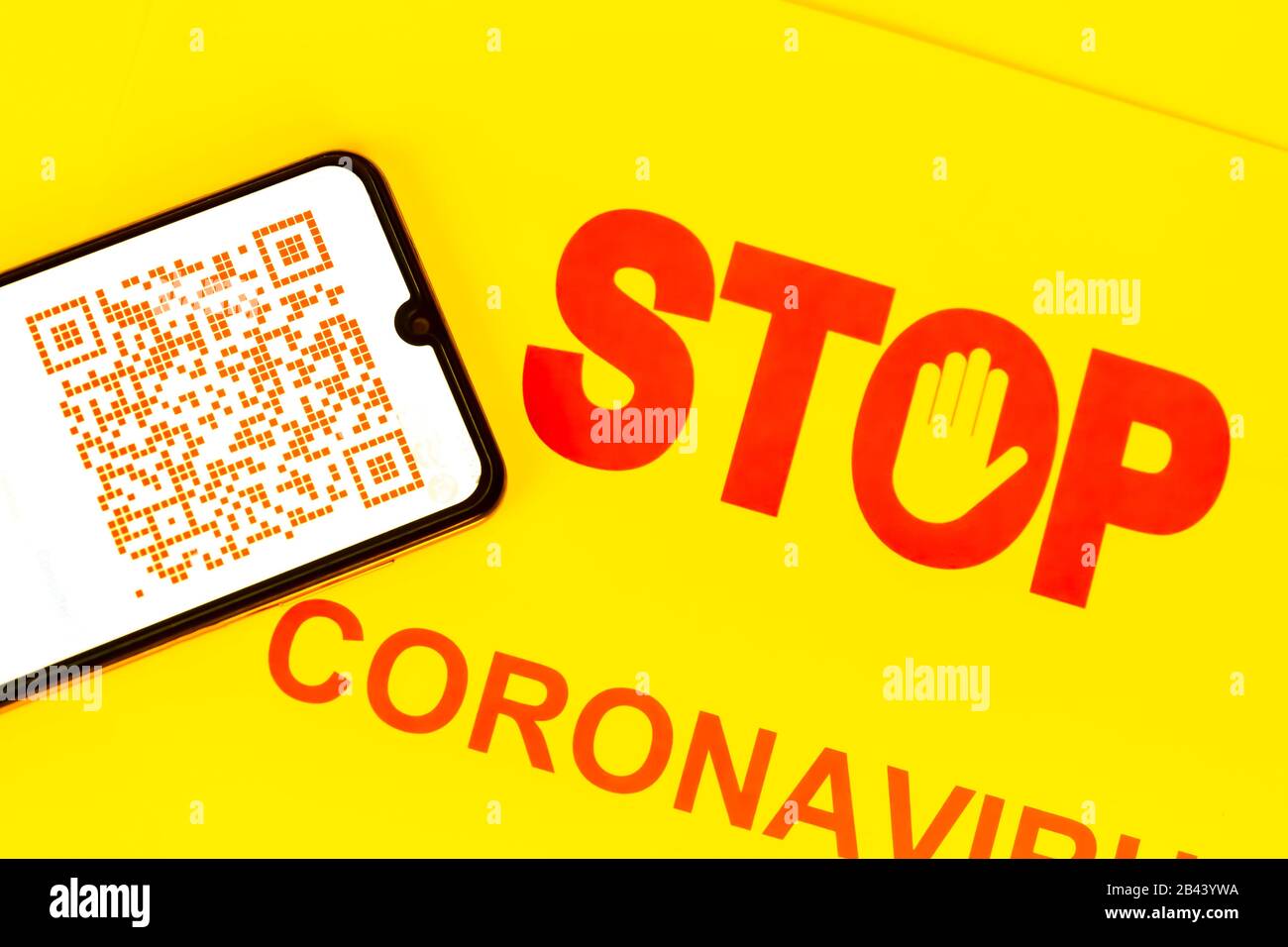 STOP Sign with orange colorful QR Code on smart phone screen for ...