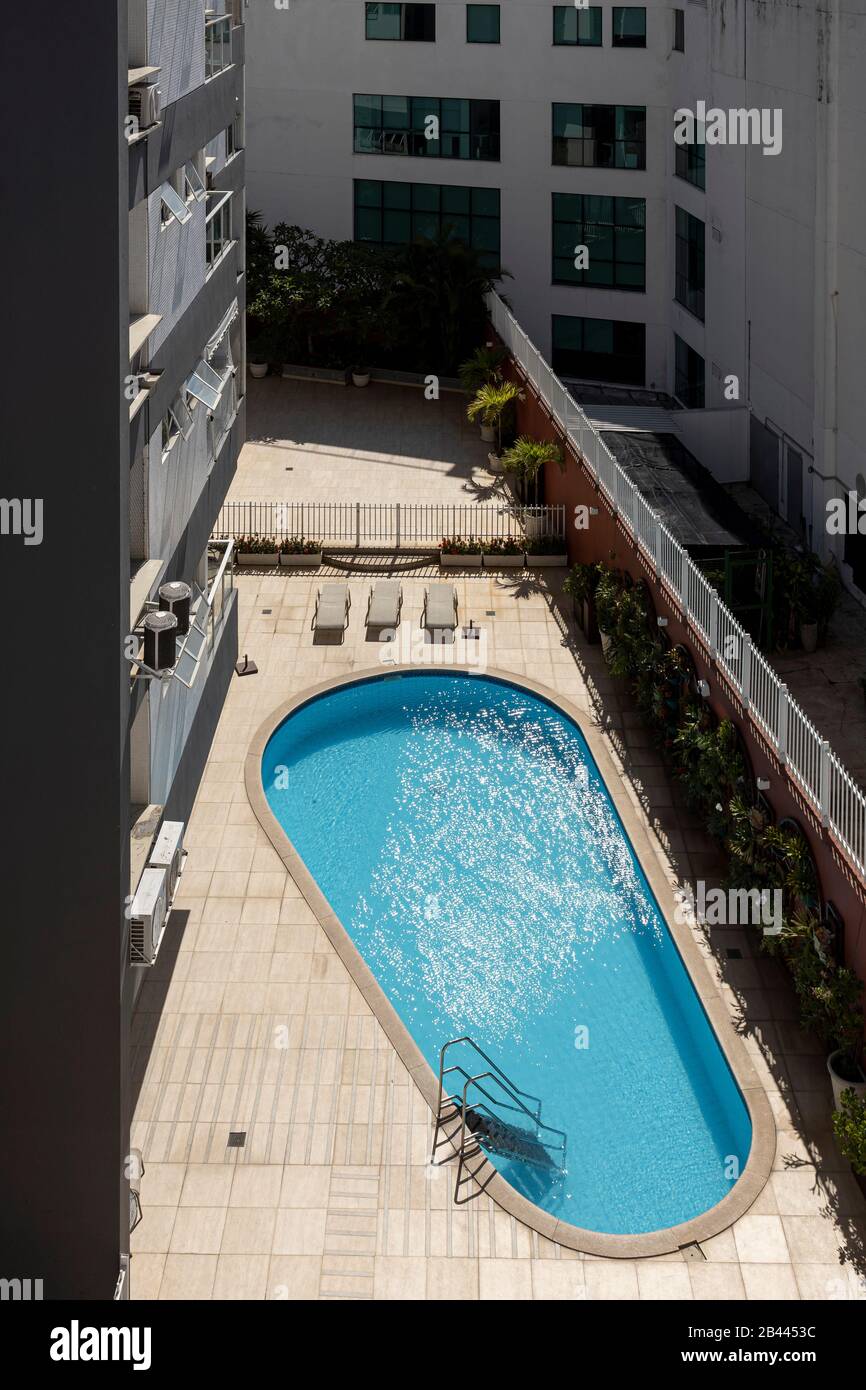 Empty swimming pool enclosed in urban surrounding part of a luxury ...