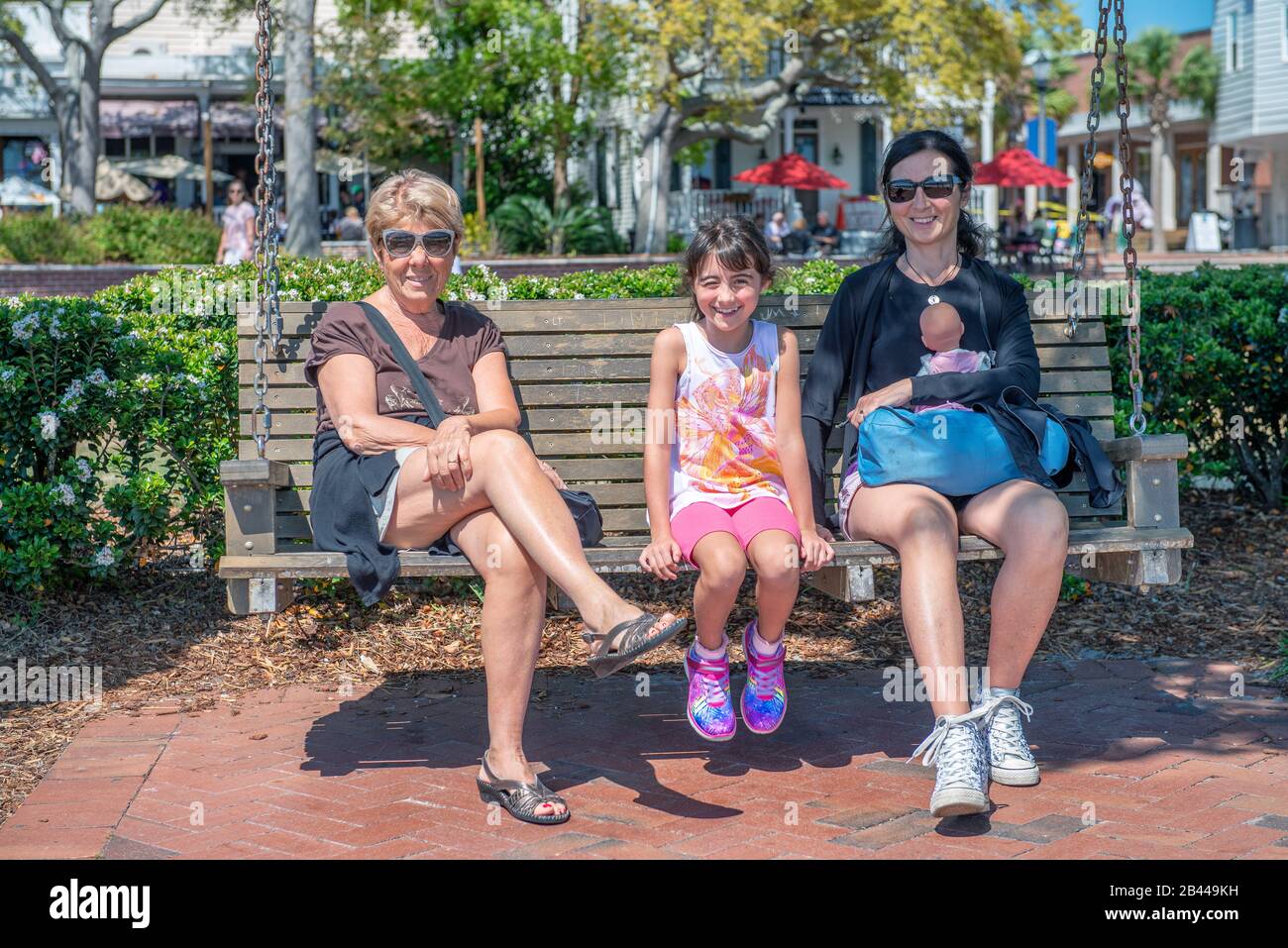 Woman and three children and bench hi-res stock photography and images ...