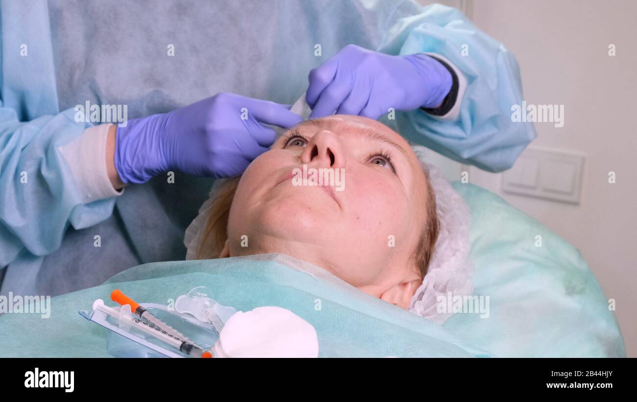 Woman getting cosmetic injection of botox, closeup. Woman in beauty ...