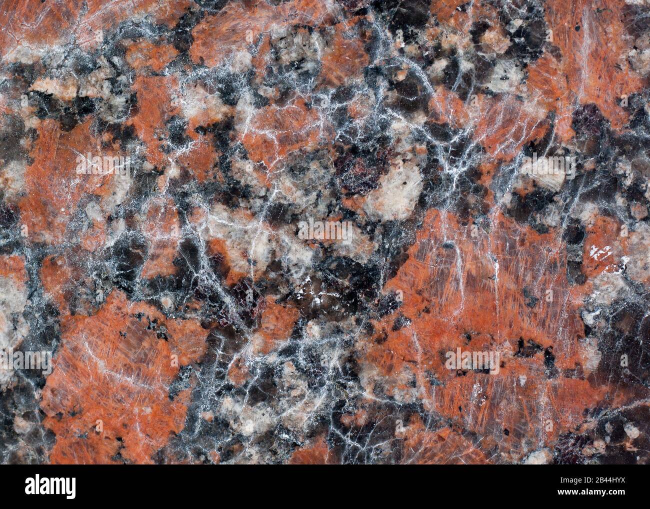 Reddish-brown granite texture with black and gray spots. Used as a ...