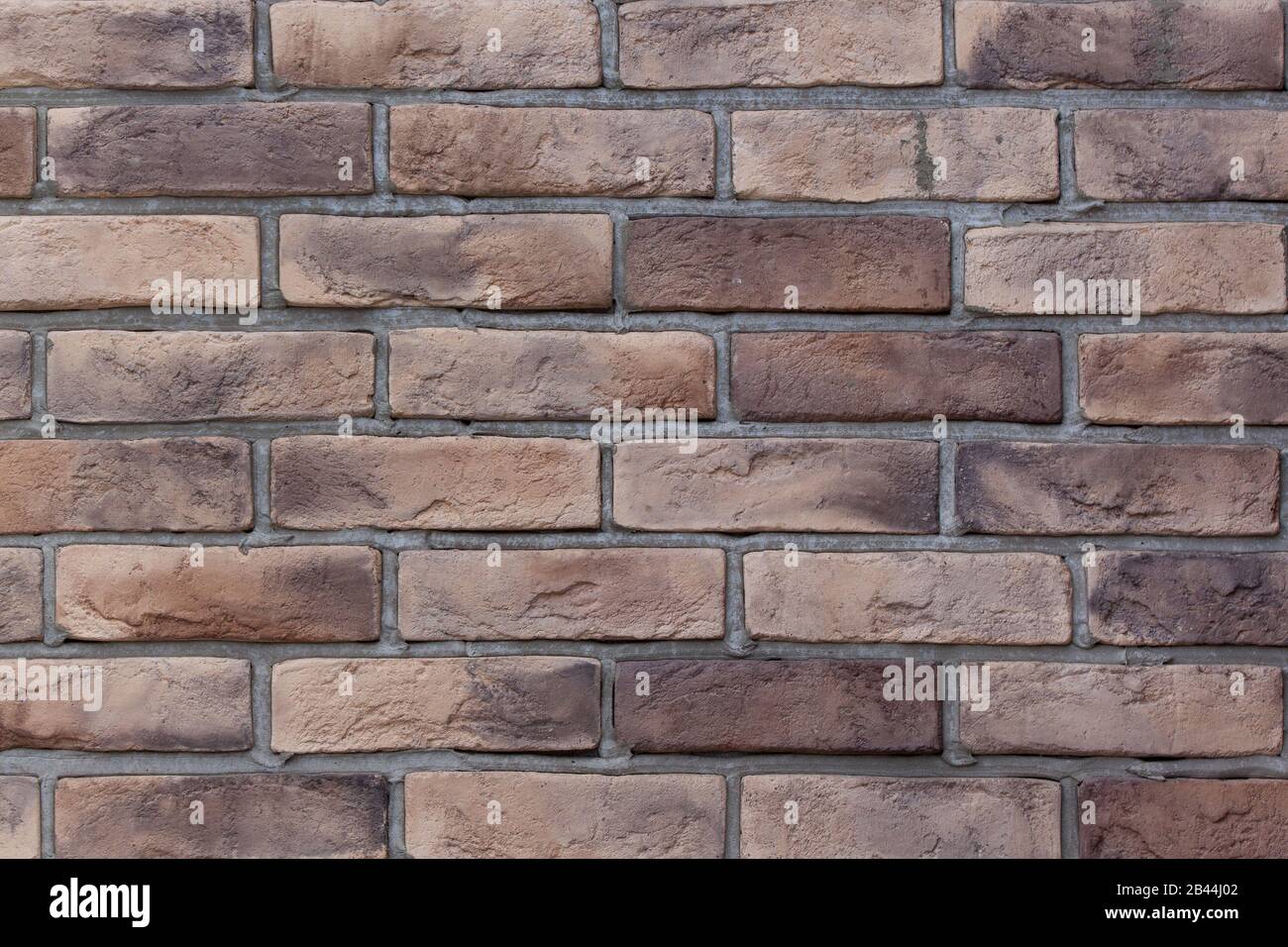 Brick wall with variegated brown bricks. Used as a background. Copy ...