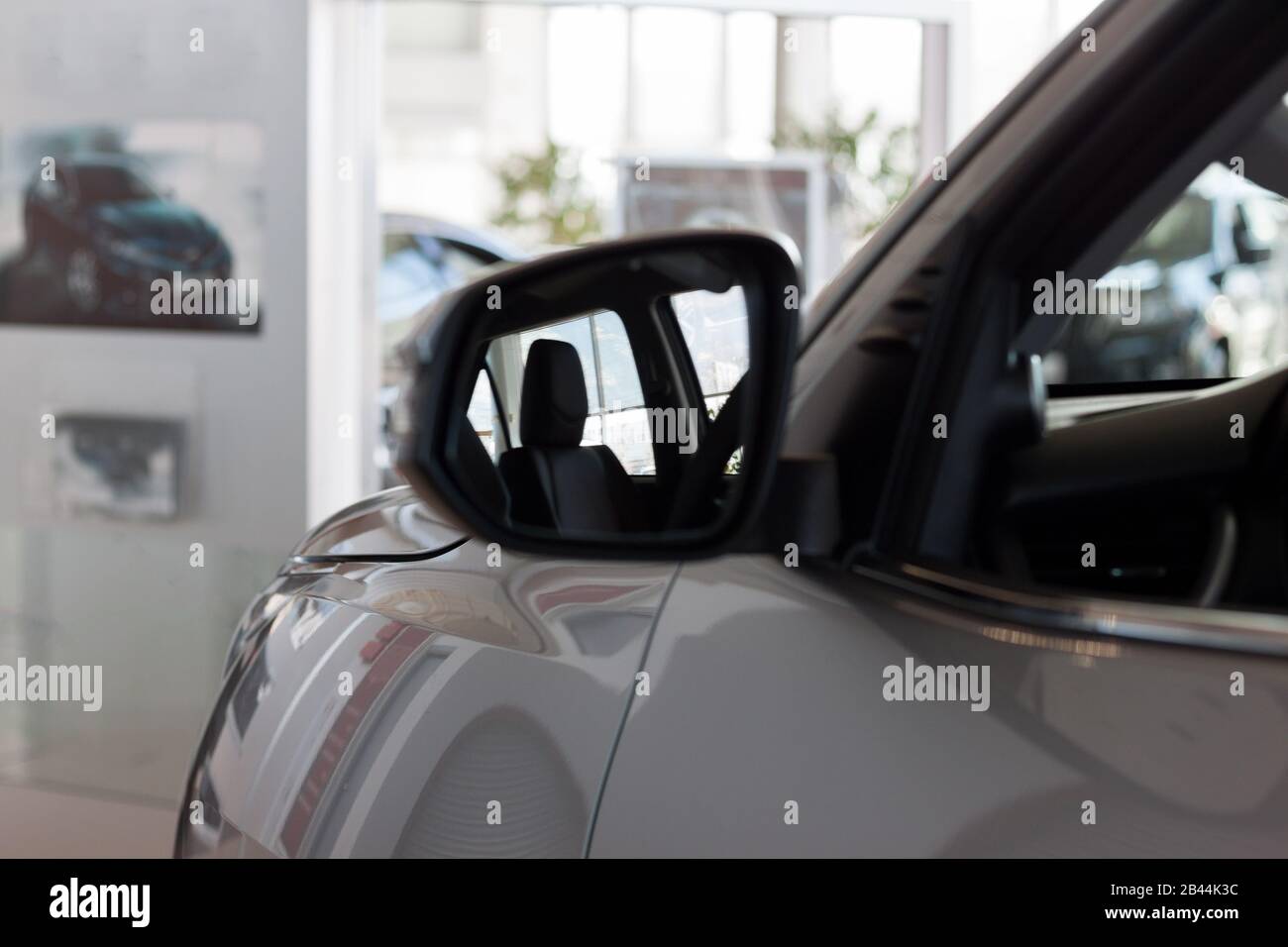 Reflection in side mirror of the interior of the new car. Modern ...