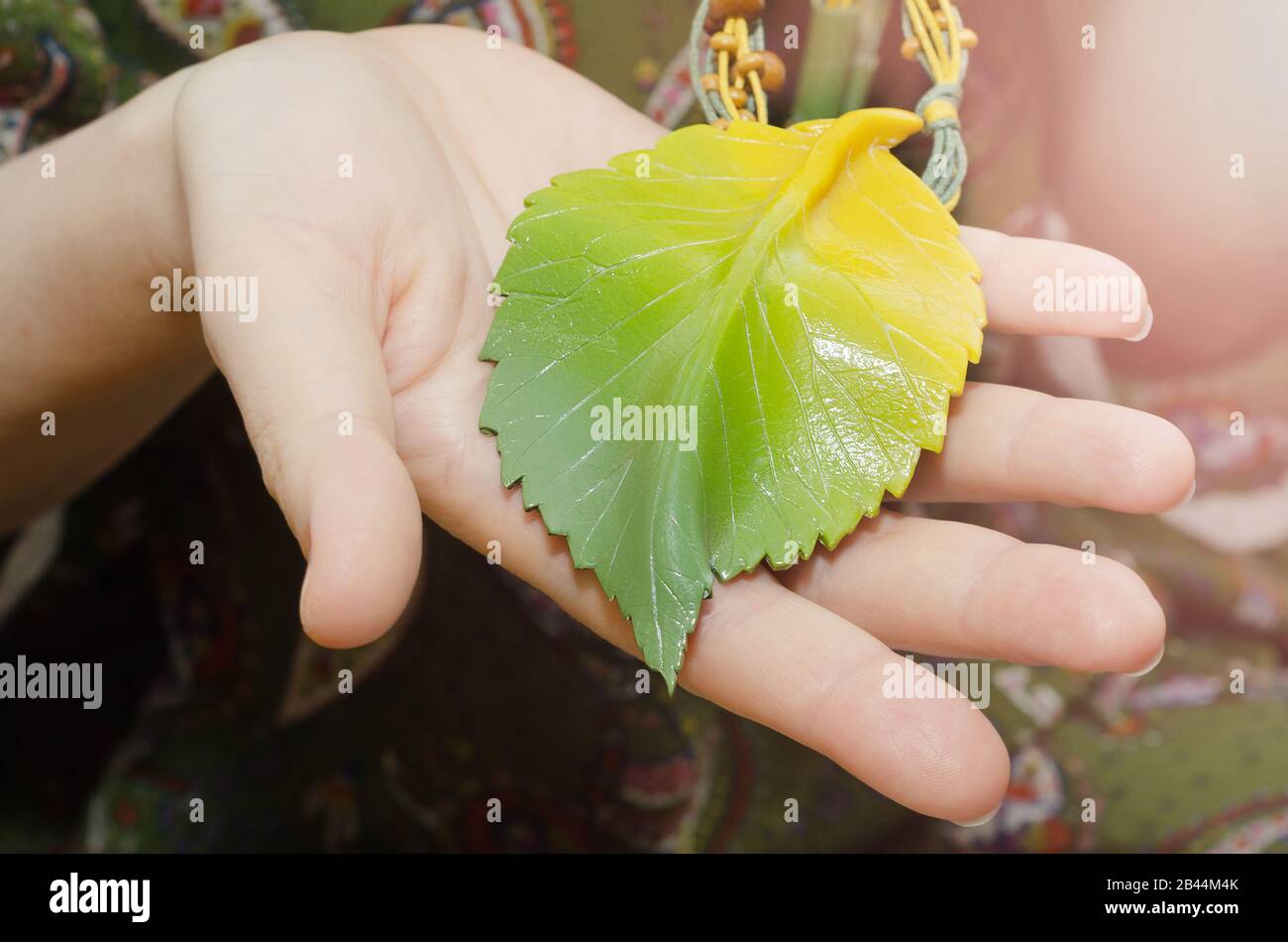 Hand and leaf hi-res stock photography and images - Alamy