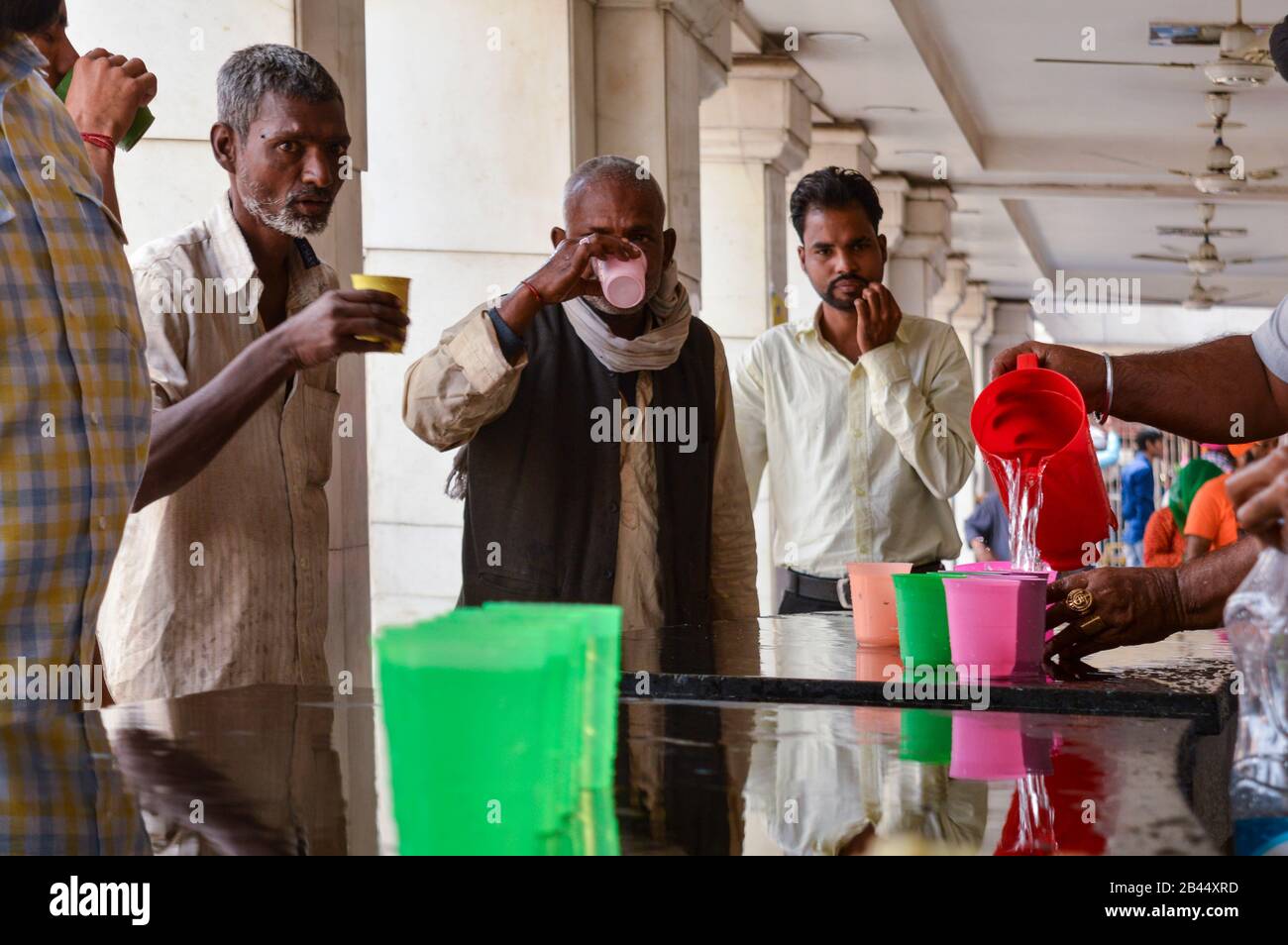 A bunch of people drinking water at free water service booth Stock ...