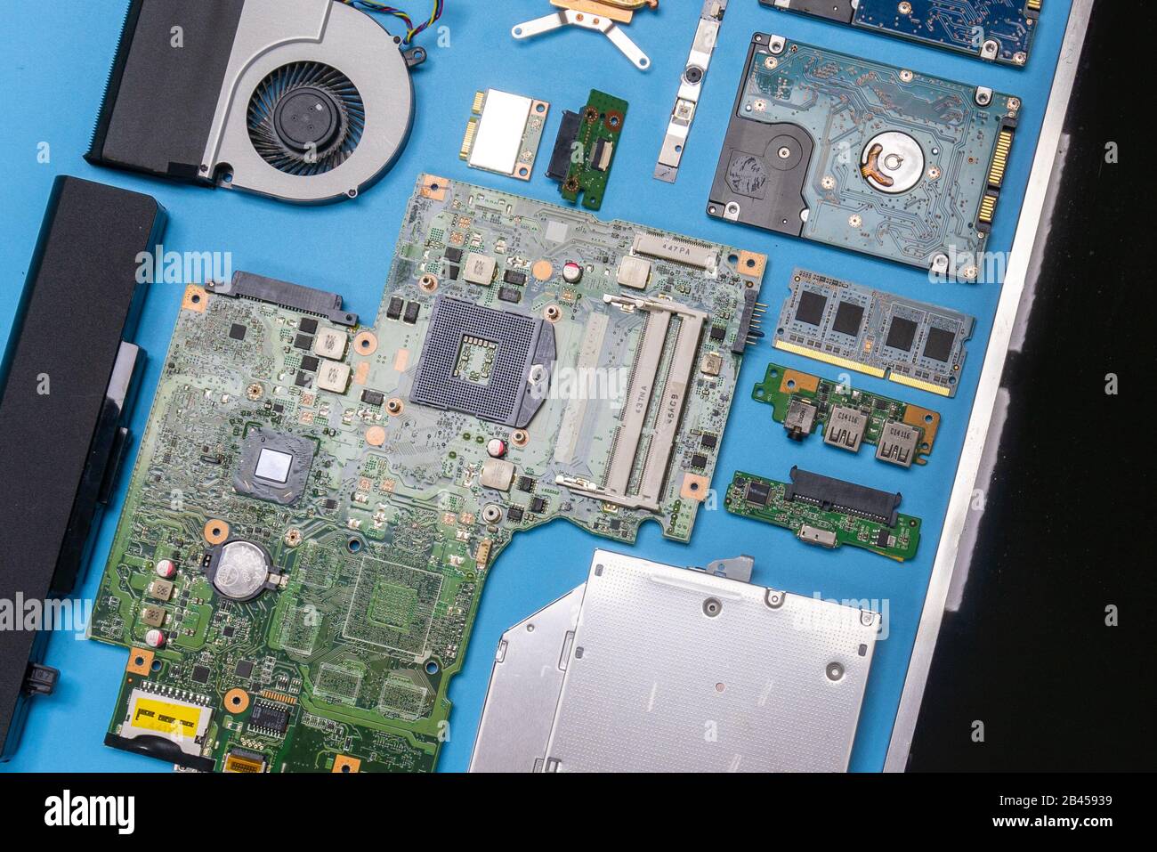 Parts of a modern computer. The insides of a laptop on a blue ...