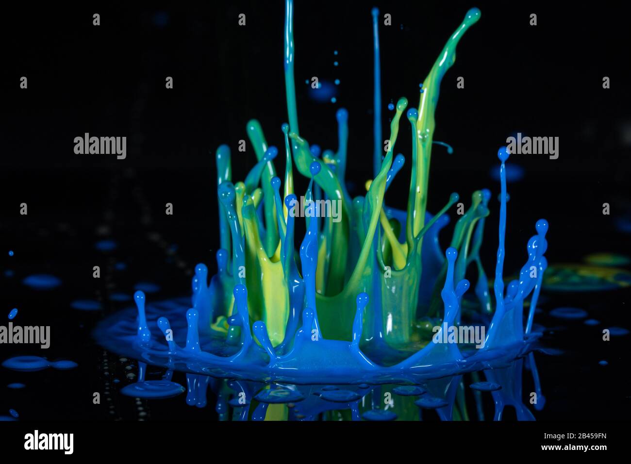 Color ink splash on a black background Stock Photo - Alamy