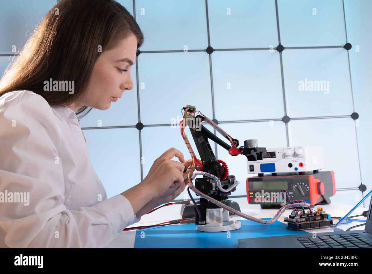 Woman student with industrial robot arm in designer laboratory Stock ...
