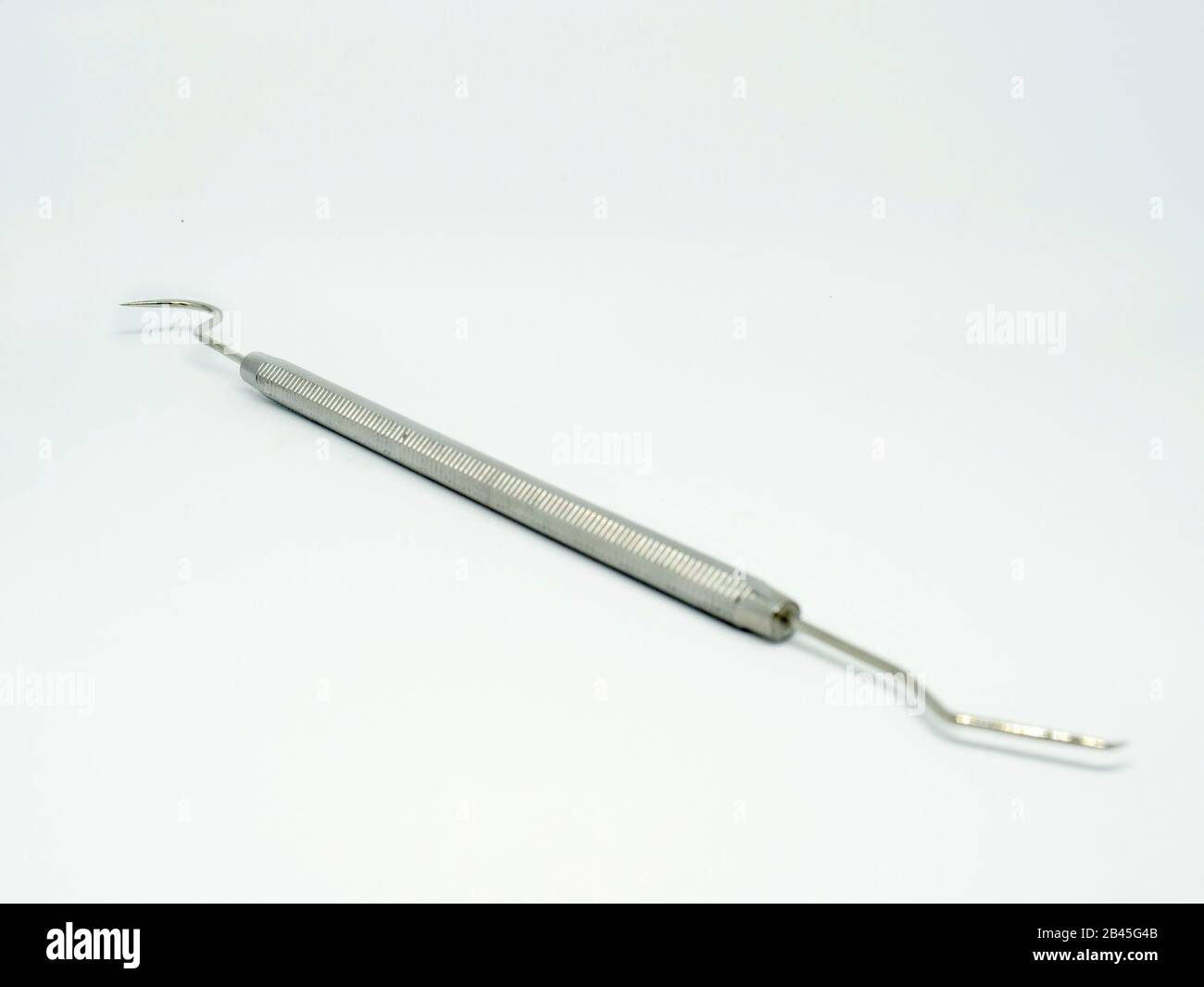 Dentist scaler angled on white background. oral hygiene Stock Photo - Alamy