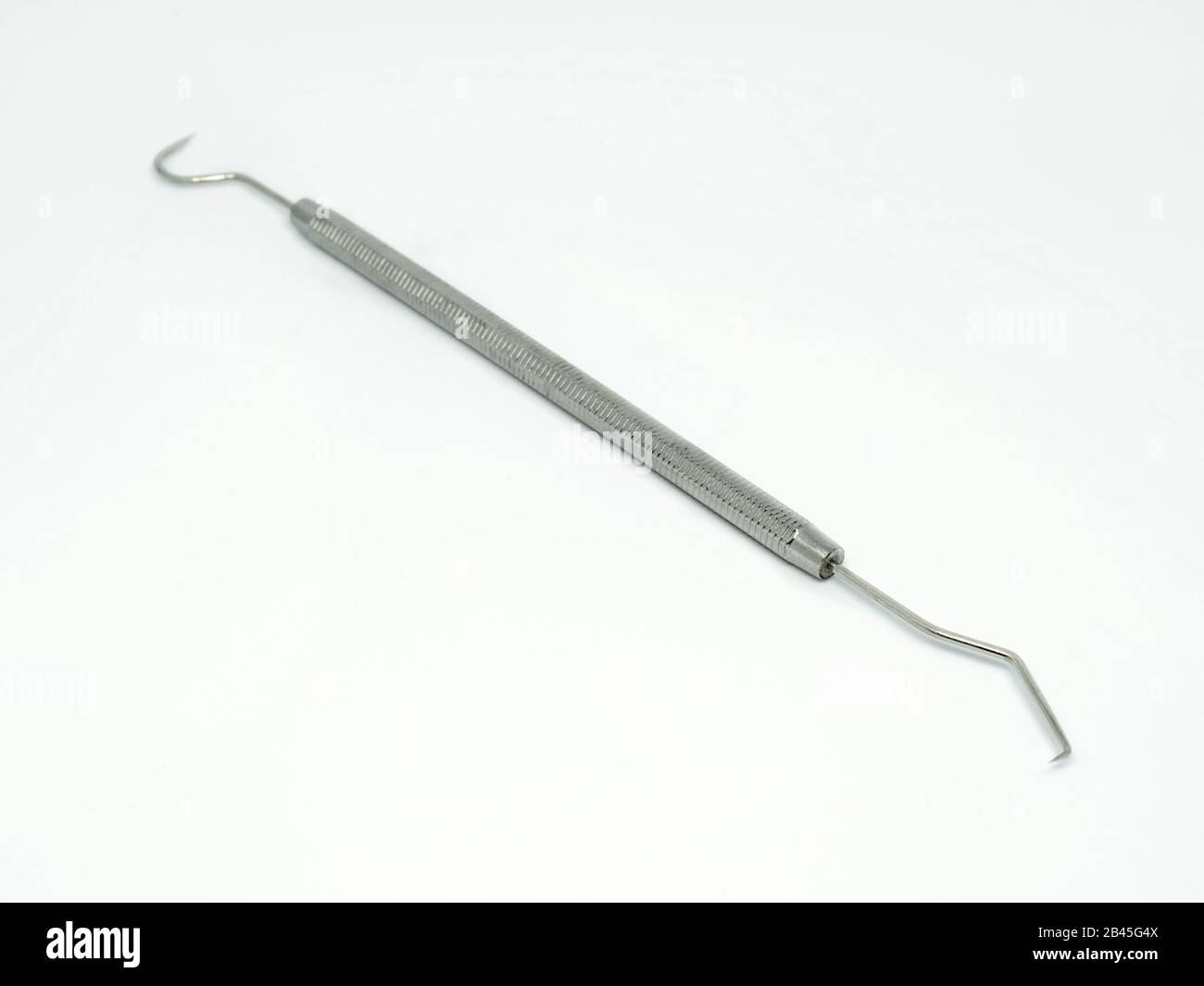 Dental sharp hook instrument on white background angled view. oral ...