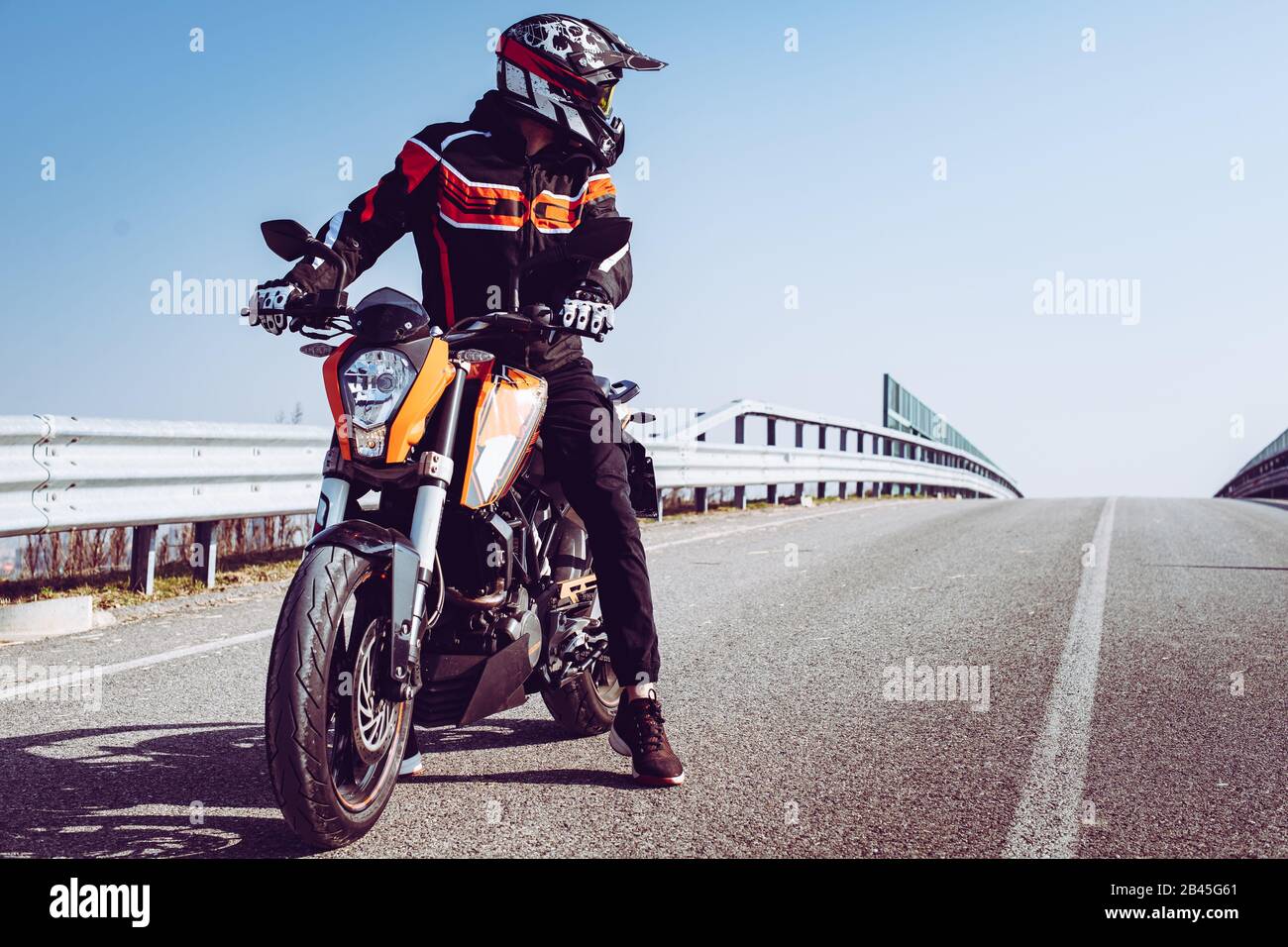 Motor biker ready to go on an empty road. Outdoors adventures and ...