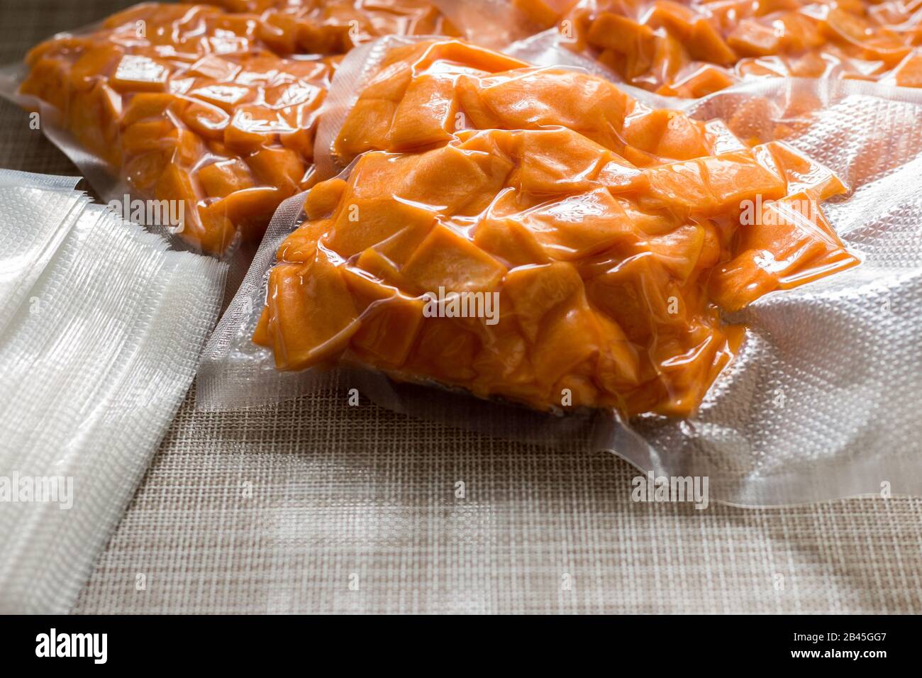 yellow pumpkin cut into slices and cubes and vacuum packed Stock Photo ...