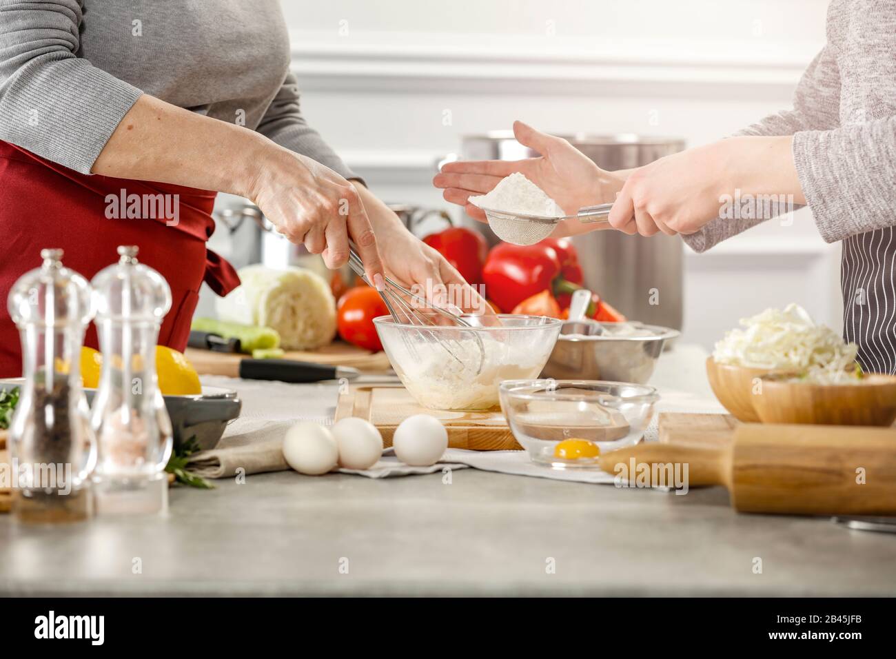 Cooking, baking and preparing meals and dishes in the kitchen. Table ...