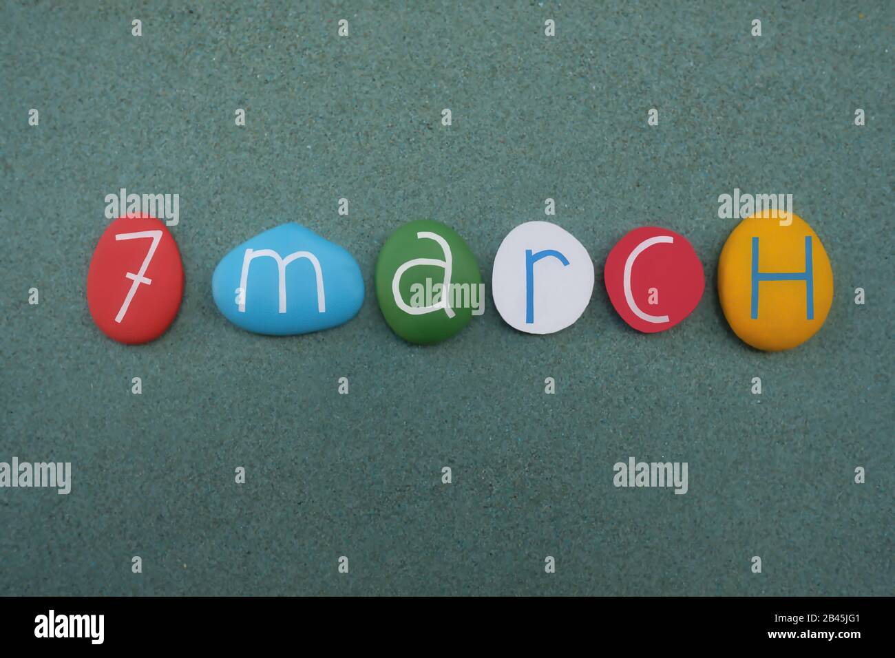 7 March, calendar date composed with colored and carved stones over ...