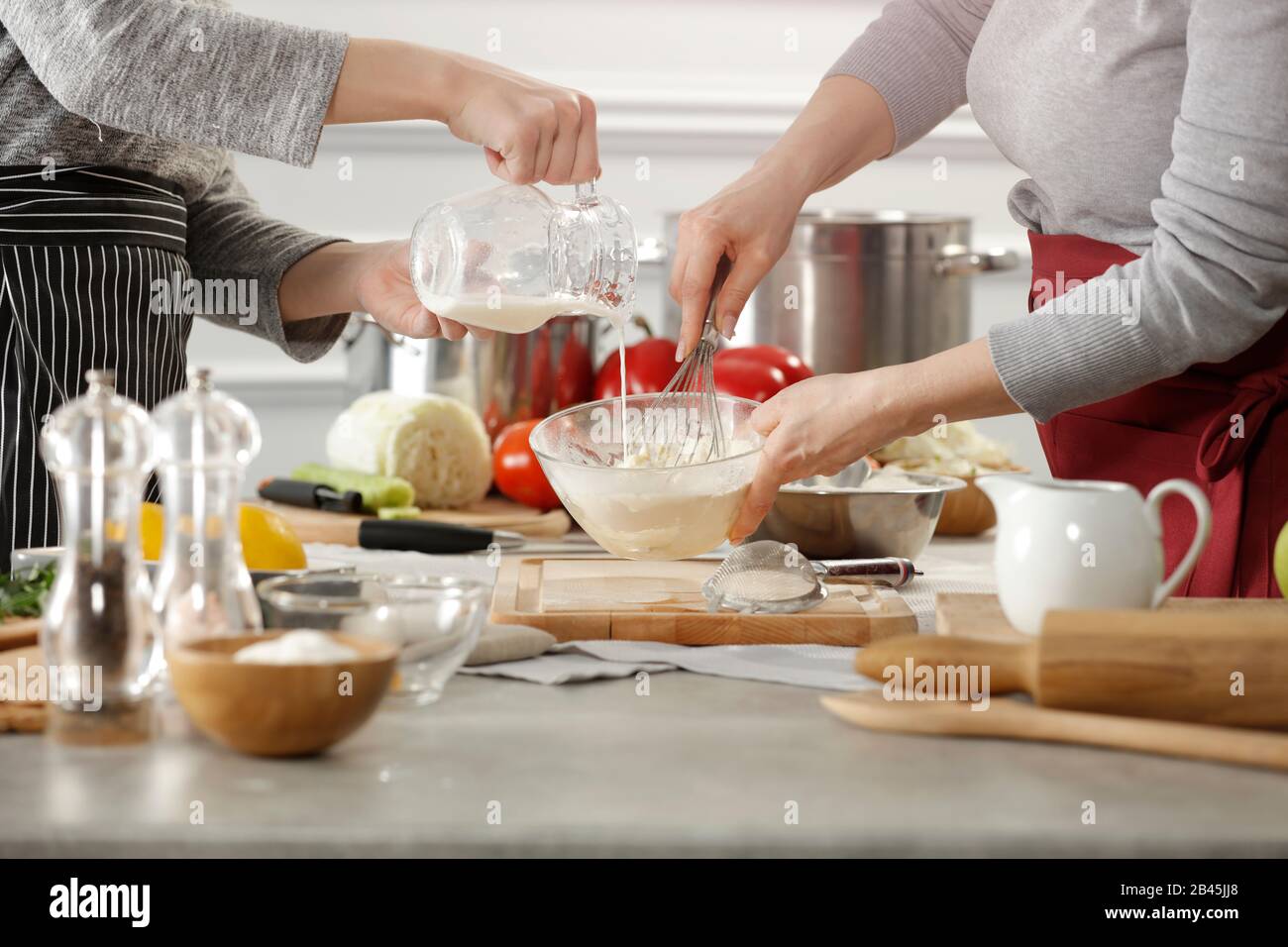 Cooking, baking and preparing meals and dishes in the kitchen. Table ...
