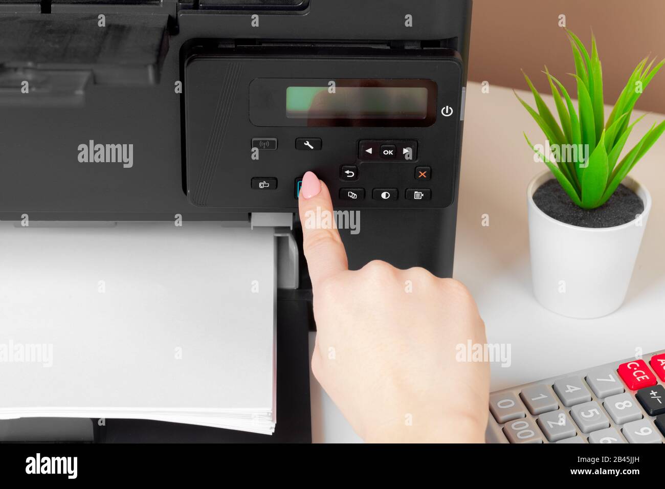 Woman using the printer to scanning and printing document Stock Photo ...