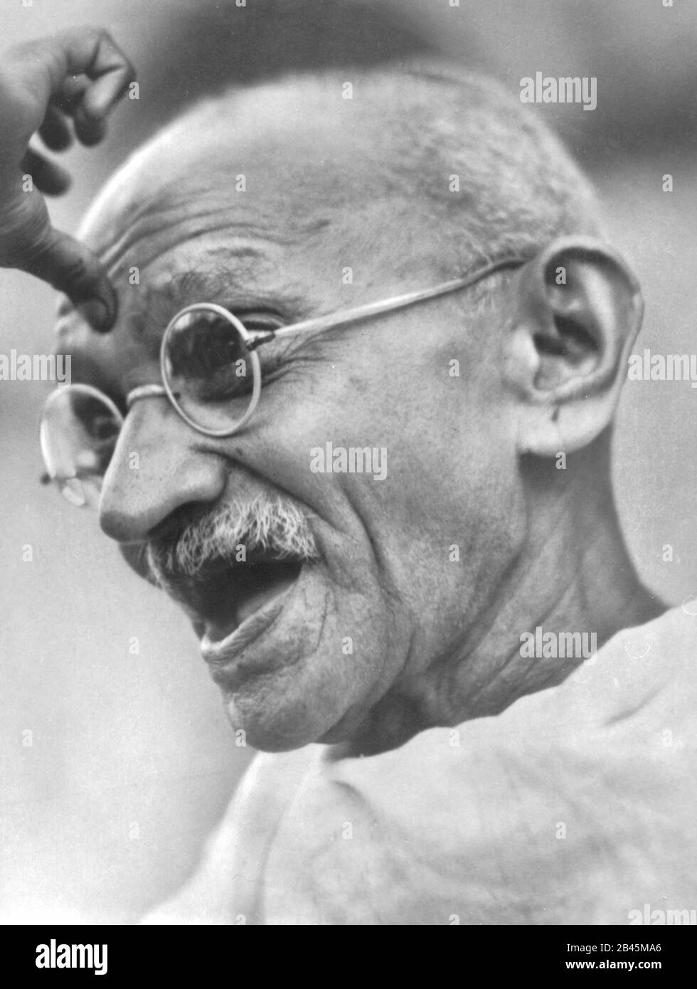 Applying tika tilak on Mahatma Gandhi forehead laughing, India, Asia ...