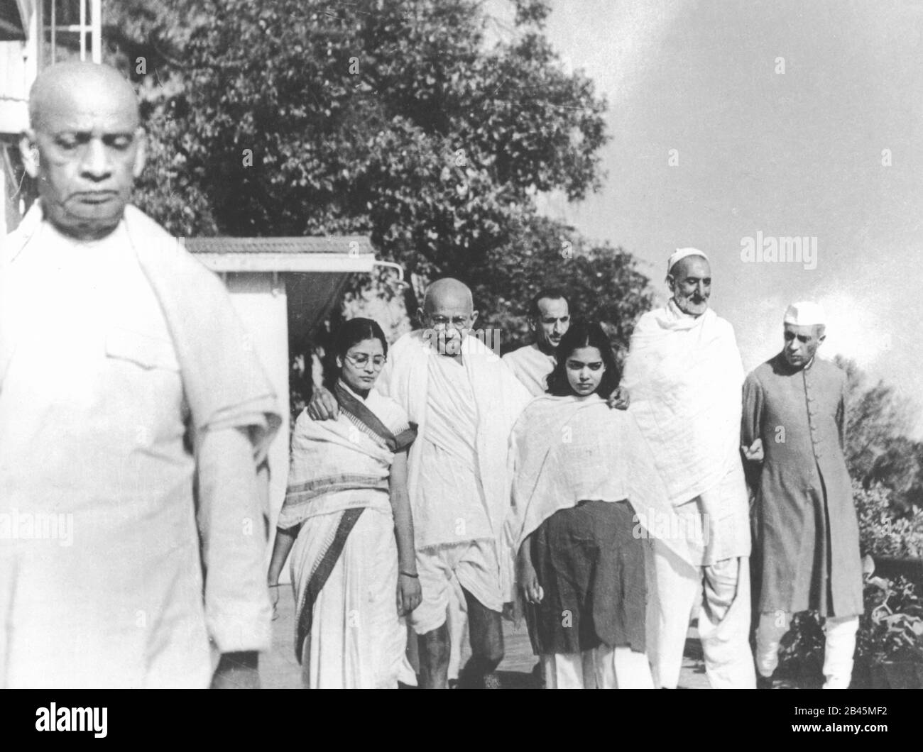 Mahatma Gandhi walking with his co-workers Sardar Vallabhbhai Patel ...