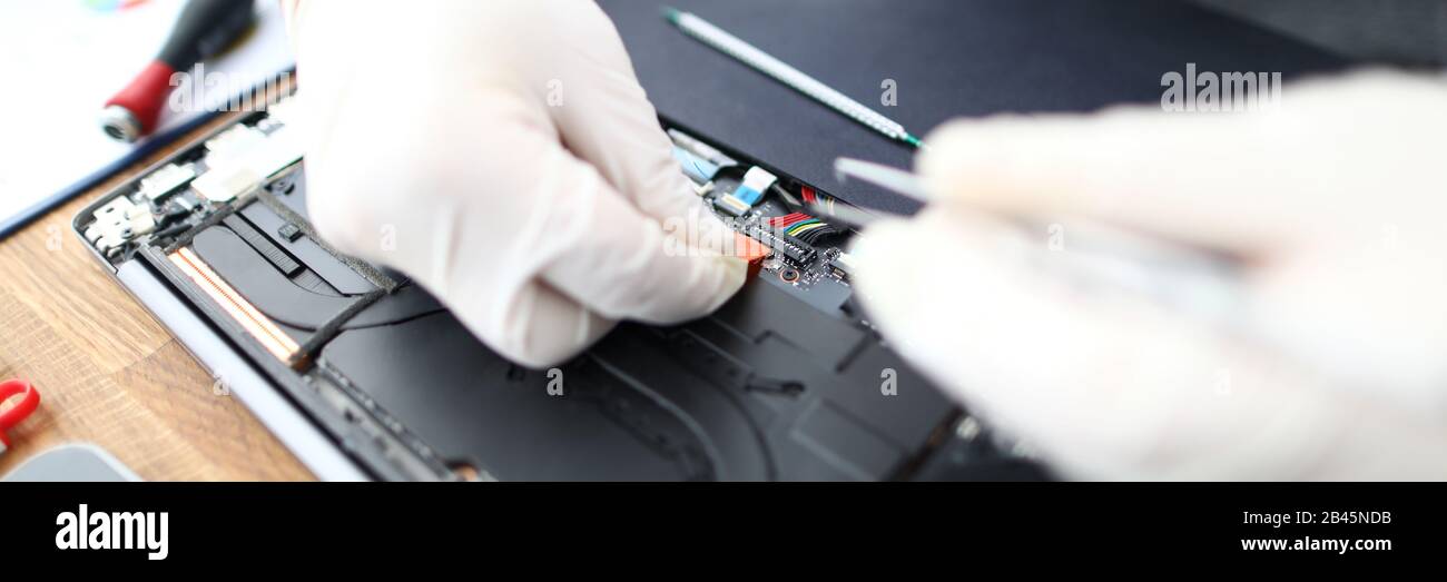 Laptop repair technician with tool Stock Photo - Alamy