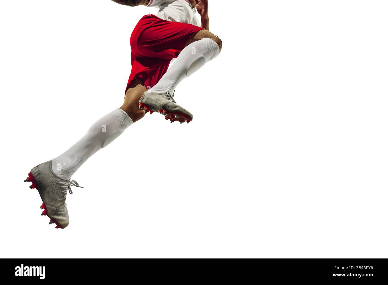 Flight. Football or soccer player on white background with grass. Young ...