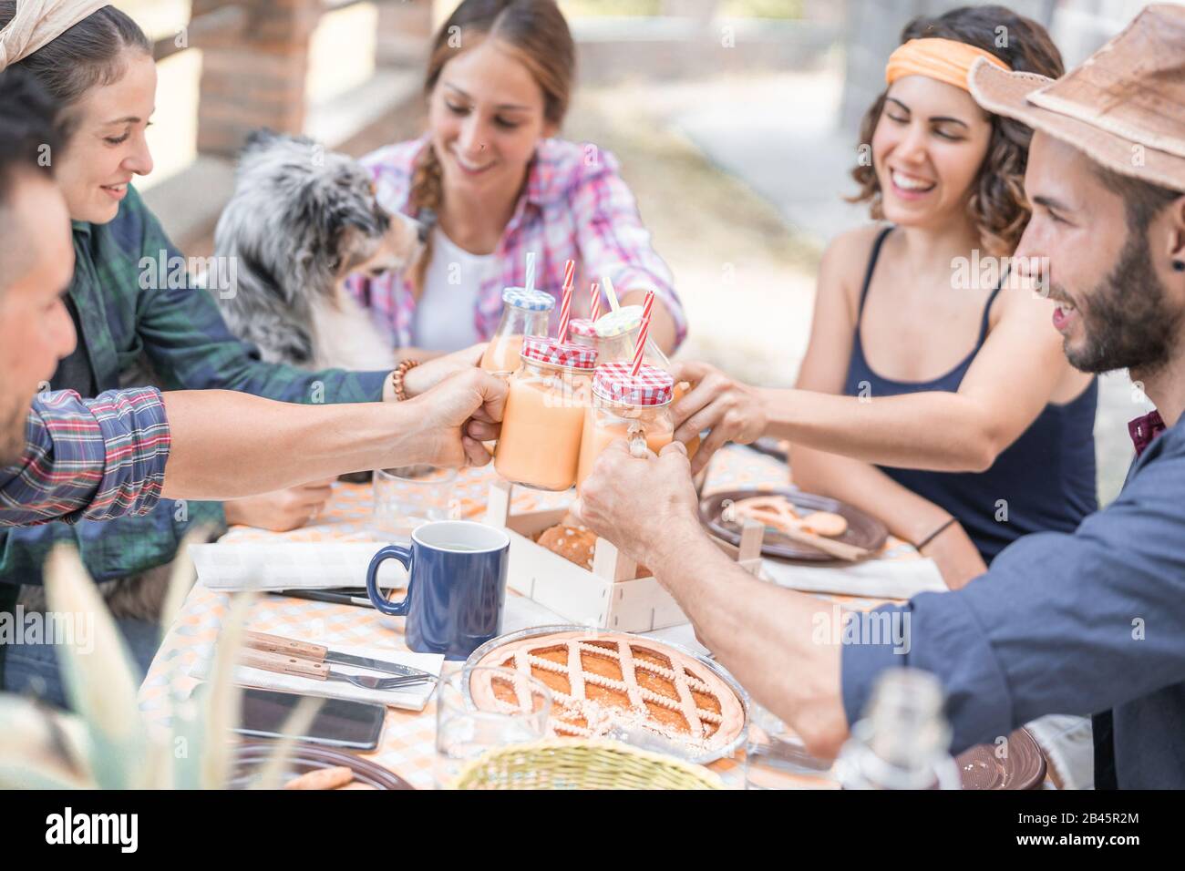 Happy friends cheering at breakfast brunch meal in nature outdoor ...