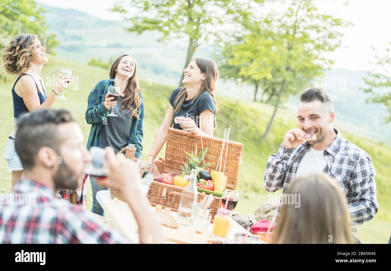 Happy millennials friends drinking wine and eating appetizer snack at ...