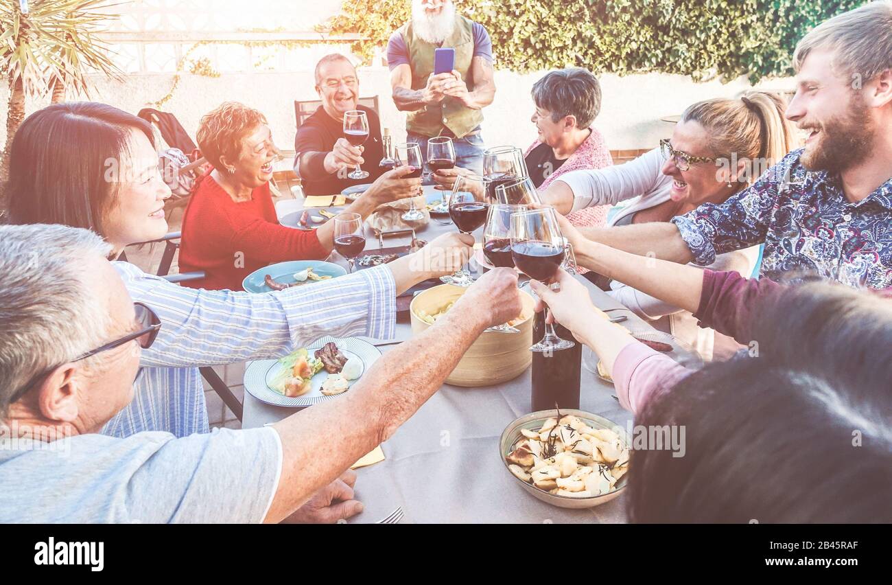 Happy family cheering with wine at barbecue dinner outdoor while ...