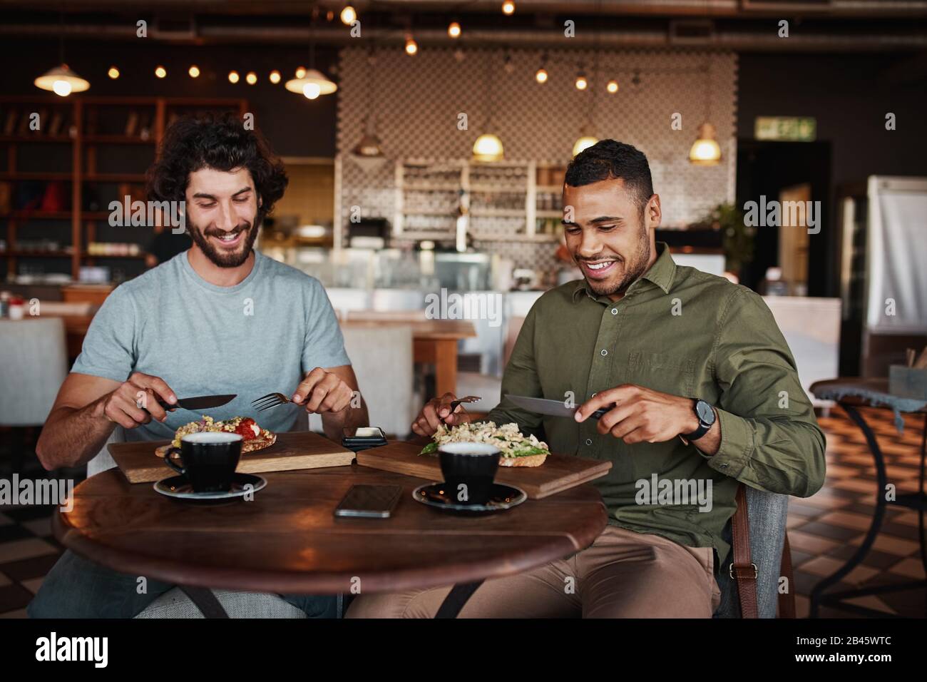 Friends enjoying italian brischetta food in cafe with coffee while ...