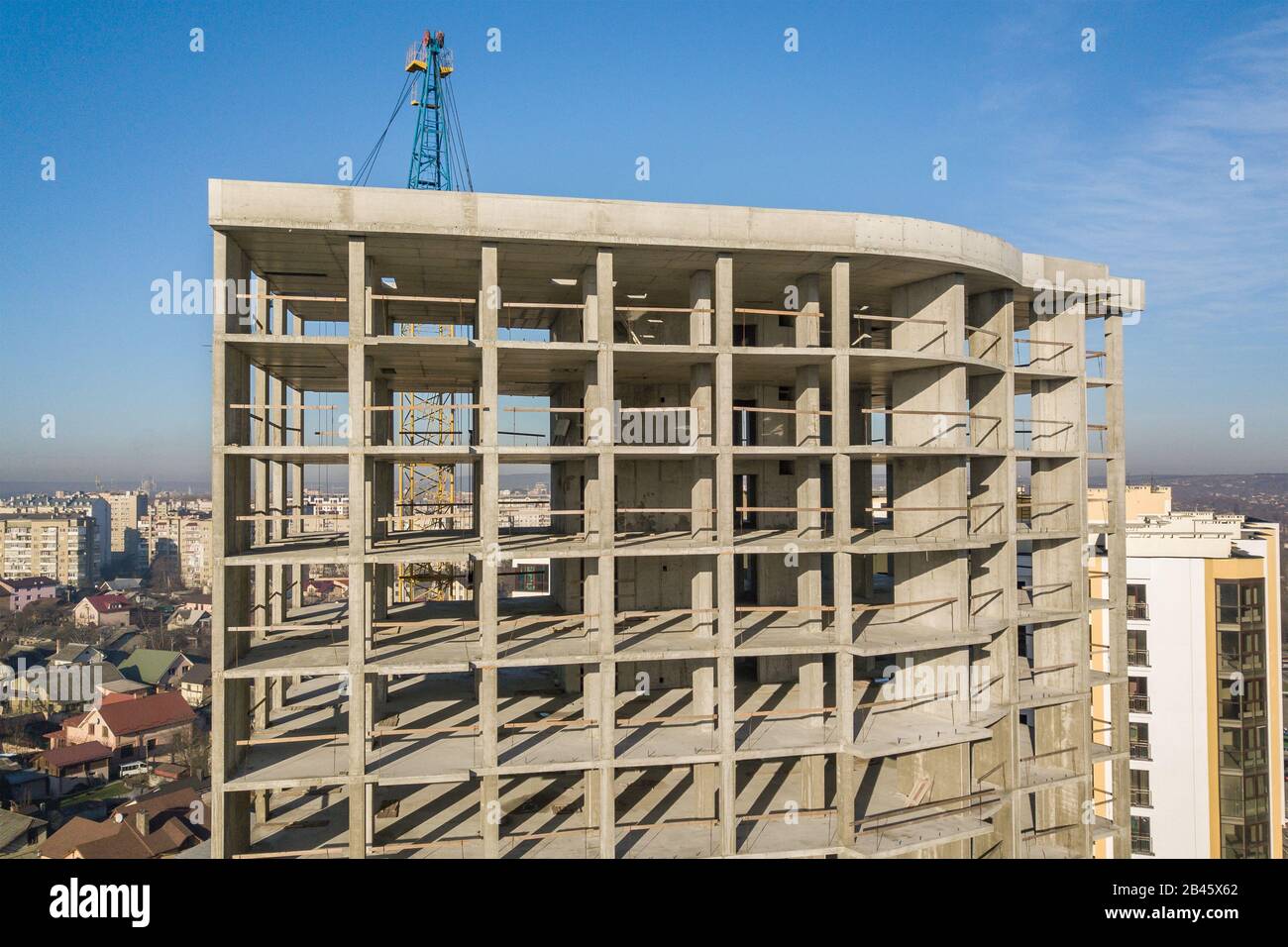 Aerial view of concrete frame of tall apartment building under ...